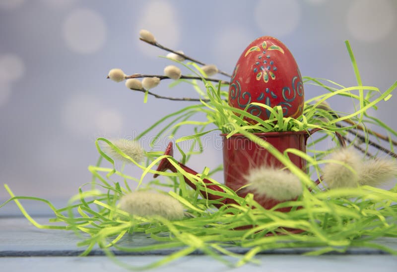One Easter Egg Stands on a Small Red Watering Can As on a Stand on a ...