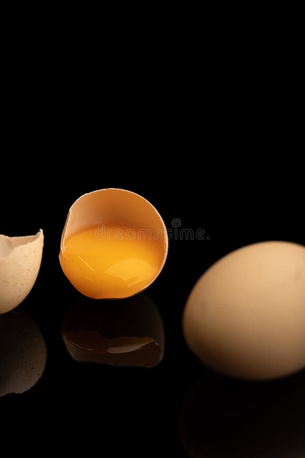 One Egg and a Broken Egg with Yellow or Orange Egg Yolk in the Shell ...