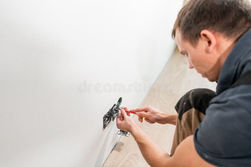 One Electrician Worker at Wiring Cable and Light Switch or Power Wall ...