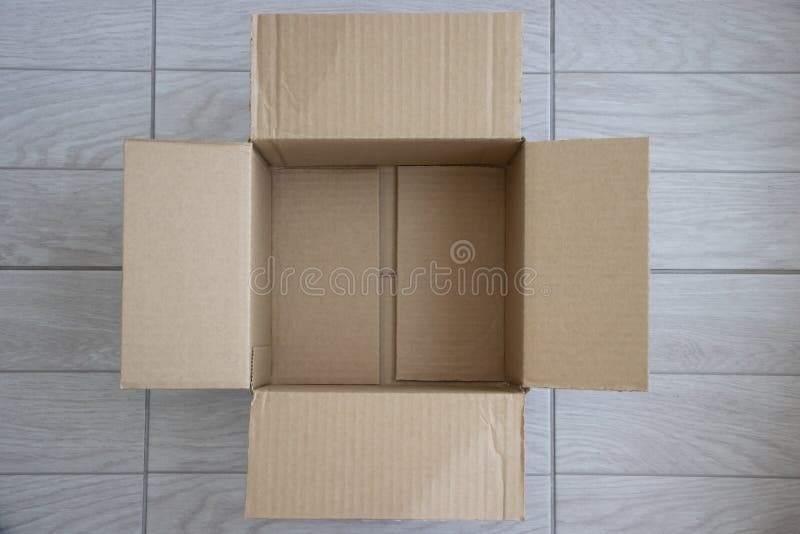One Empty Open Cardboard Box on the Wood Floor Stock Photo - Image of ...