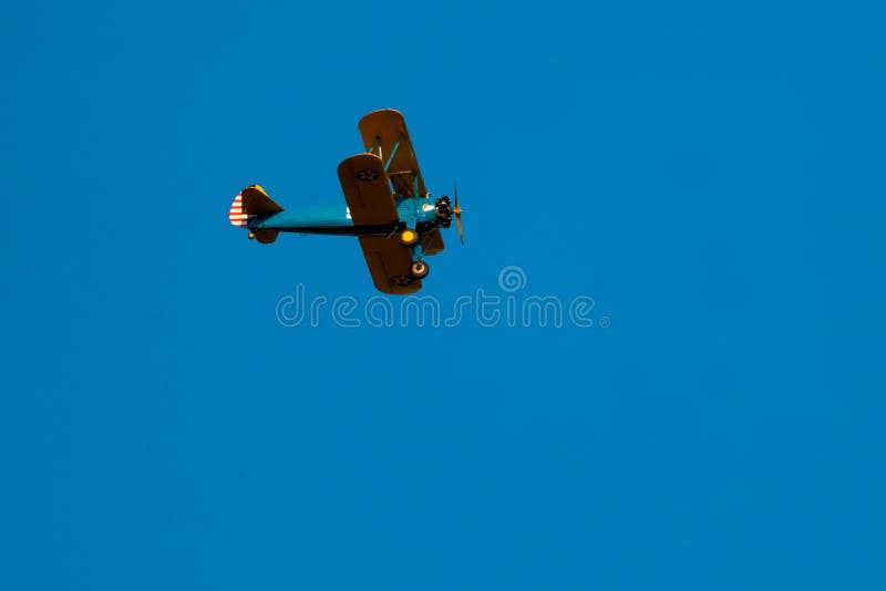 Biplane flying in blue sky stock photo. Image of flight - 224743430