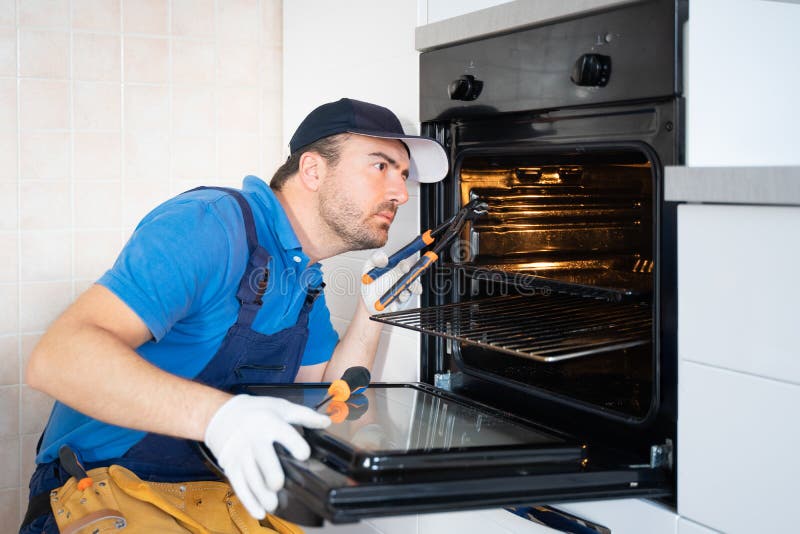 One Expert Repairman Fixing a Broken Kitchen Oven Stock Image - Image ...