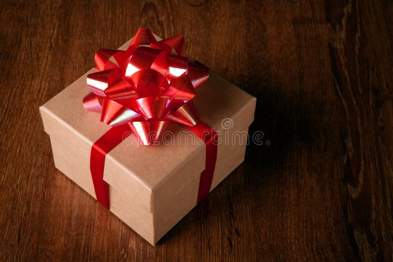 One Festive Gift Box with a Red Bow on a Wooden Stock Image - Image of ...