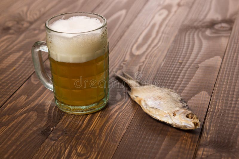 Fish on frothy beer stock photo. Image of refreshment - 67496510
