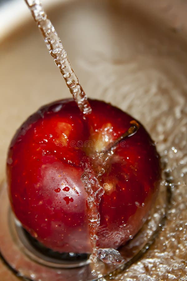One Fresh Red Apple Under Running Water. Apple with Drops of Water ...
