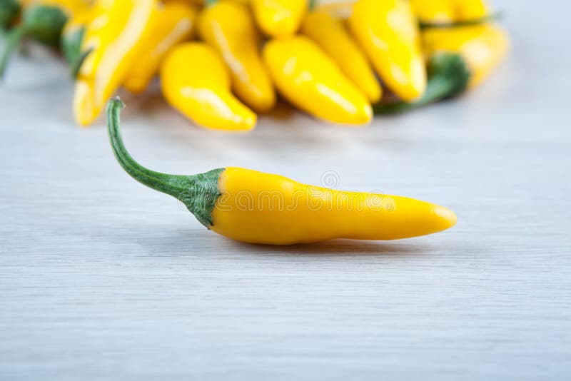The One Fruit of Yellow Fresh Chilli Pepper Against the Rest of Stock ...