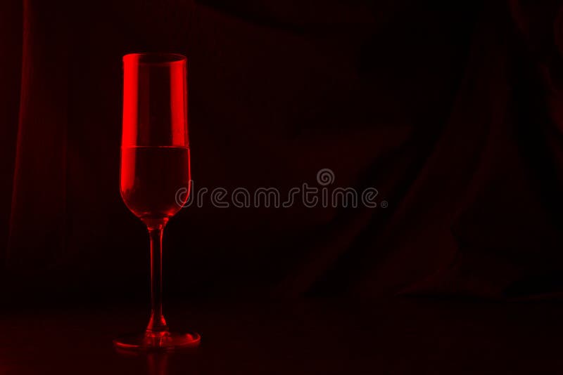 One glass in red light stock photo. Image of colors - 135465174