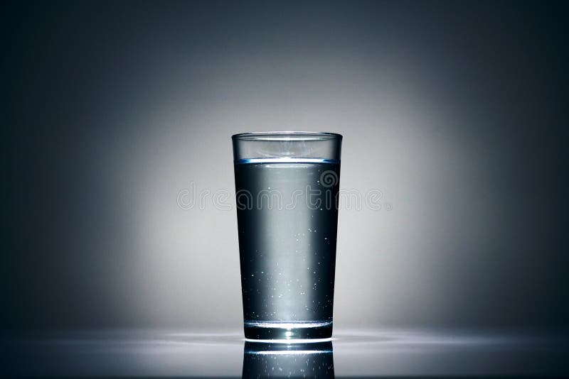 One Glass of Water Full of Ice Cubes, White Background, Blue Toned ...