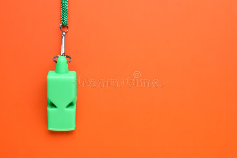 One Green Whistle with Cord on Orange Background, Top View. Space for ...