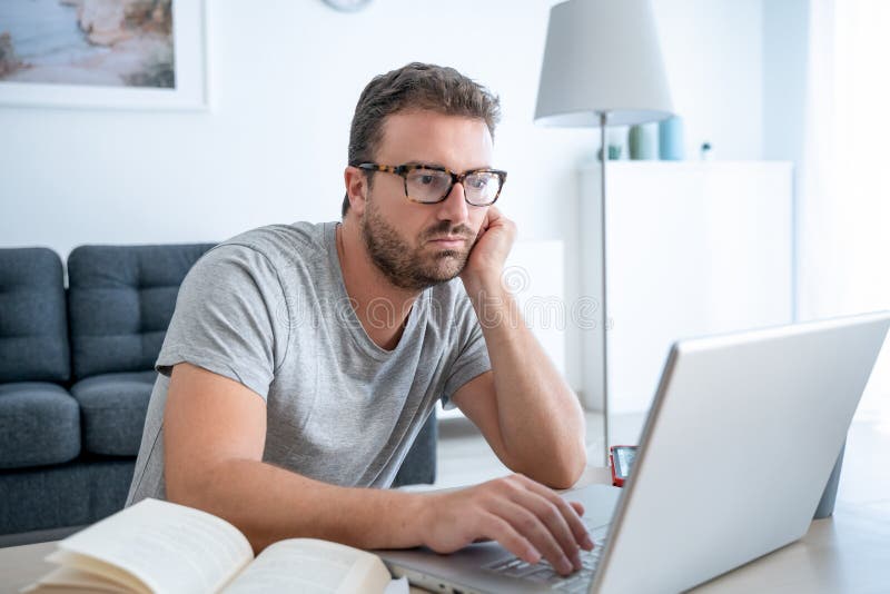 One Guy Studying at Home Sitting in Front of His Computer Stock Photo ...