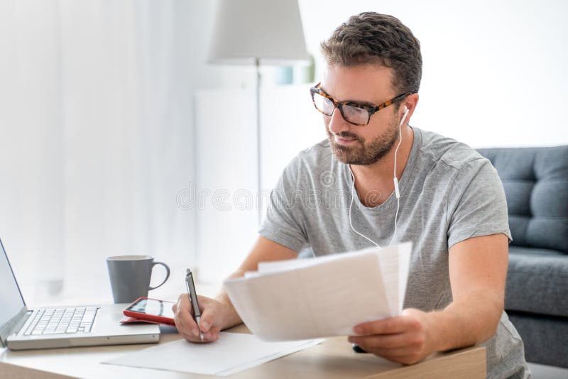 One Guy Studying at Home Sitting in Front of His Computer Stock Photo ...
