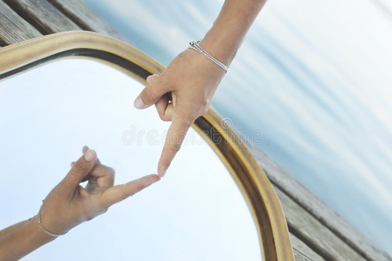 One Hand Gently Touches the Reflection of the Same Hand on the Mirror ...