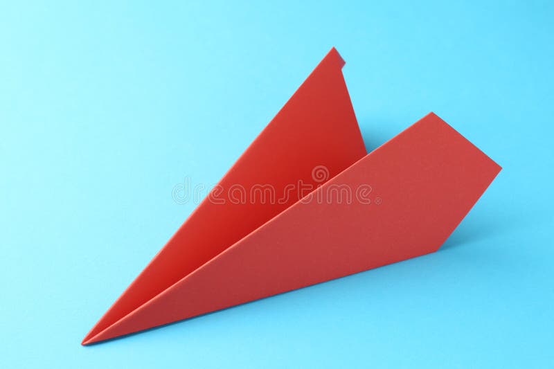 One Handmade Coral Paper Plane on Light Blue Background Stock Image ...