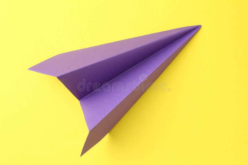 One Handmade Purple Paper Plane on Yellow Background, Top View Stock ...
