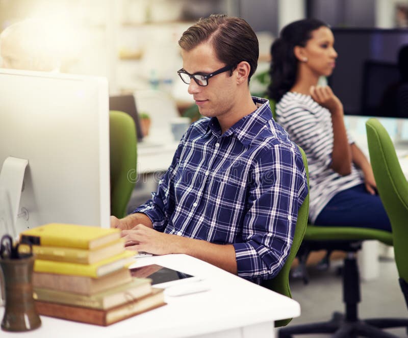 One Hundred Percent Focused. a Colleagues at Work on Computers in an ...
