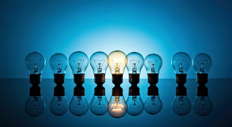 One Illuminated Light Bulb Standing Out among Unlit Bulbs on Reflective ...