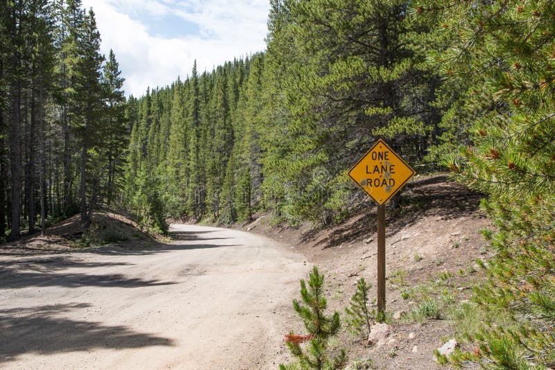 One Lane Road Sign in the Mountains Stock Image - Image of outside ...
