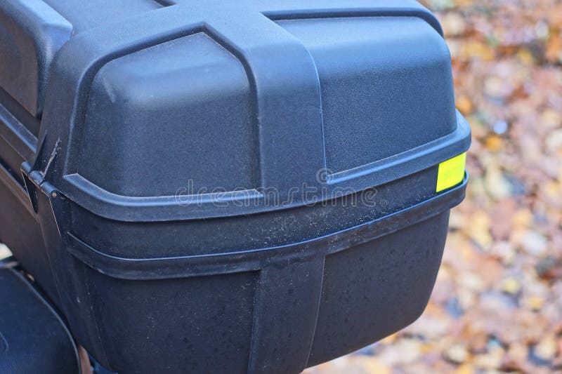 One Large Black Closed Plastic Box Container Stands on the Trunk of a ...
