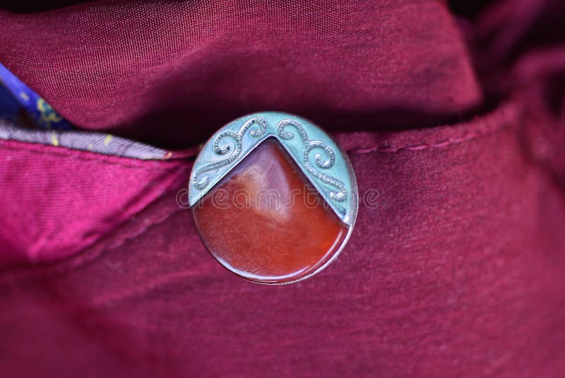 One Large Round Colored Plastic Button on Red Fabric Stock Photo ...