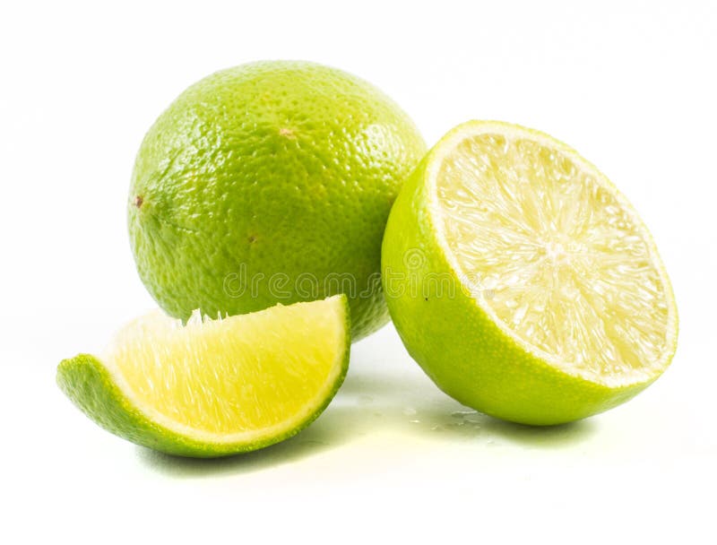 One Lime, Another Cut in Half and a Small Piece on a White Background ...