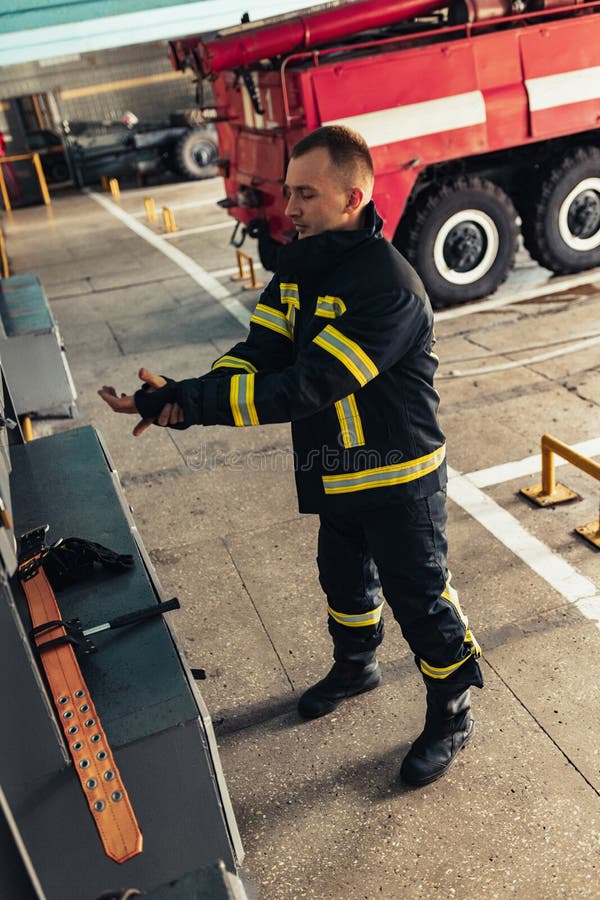 Male Firefighter Holding Fire Extinguisher in Truck Stock Image - Image ...