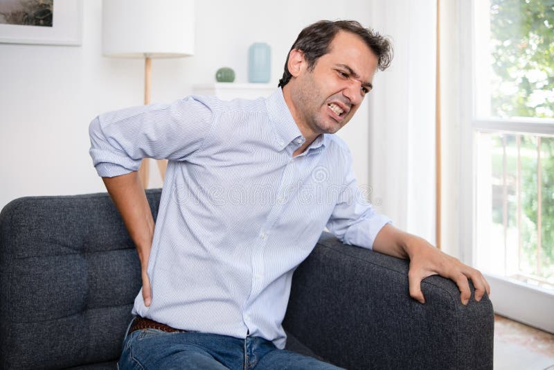 One Man Feeling Backache Seated on the Sofa Stock Image - Image of room ...