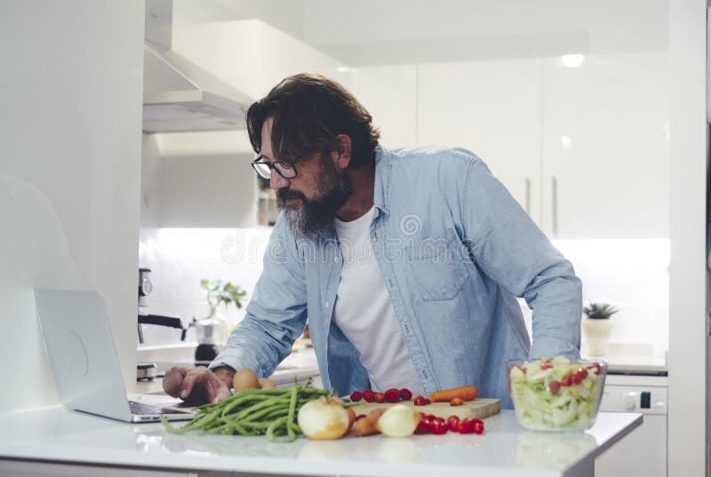 One Man at Home Preparing Fresh Healthy Salad Using Online Tutorial ...