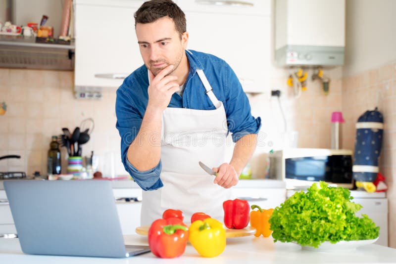 One Man is Learning To Cook Watching Video Online Stock Image - Image ...