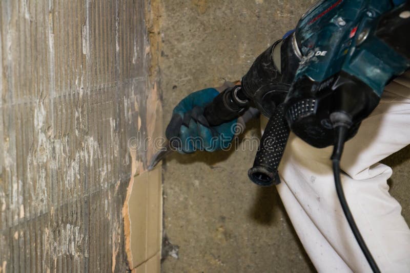 One Man Packs Tiles with a Demolition Hammer Stock Image - Image of ...