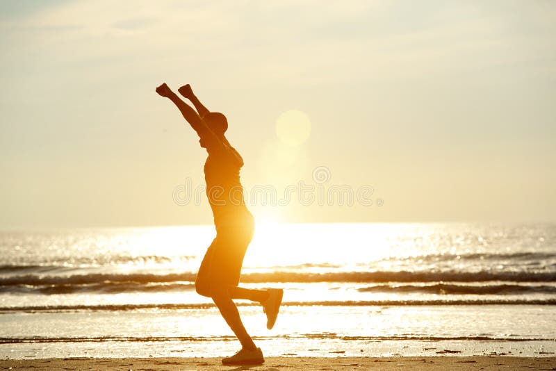 One Man Running on Beach with Arms Raised Stock Photo - Image of action ...
