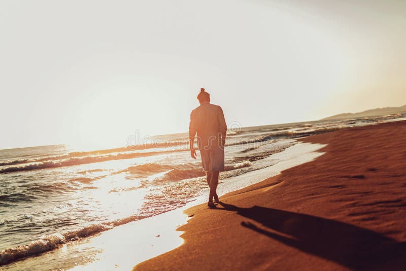 Man Walking On The Beach On Sunset. Stock Photo - Image of walk, sunset ...