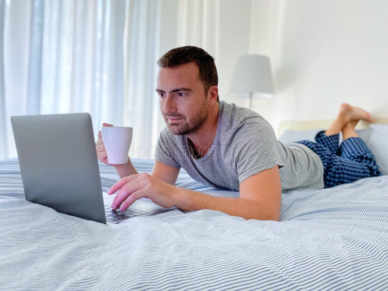 One Man is Working with Computer in Bed for Remote Work Stock Image ...