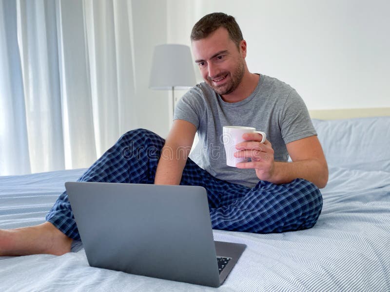 One Man is Working with Computer in Bed for Remote Work Stock Photo ...