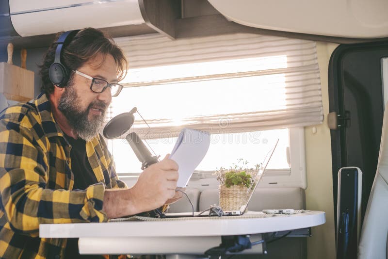 One Man Working Inside Camper Van with Microphone and Headset for ...