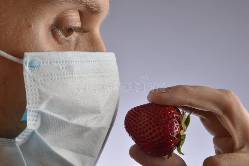 Eating a Strawberry through a Face Mask Stock Photo - Image of obstacle ...