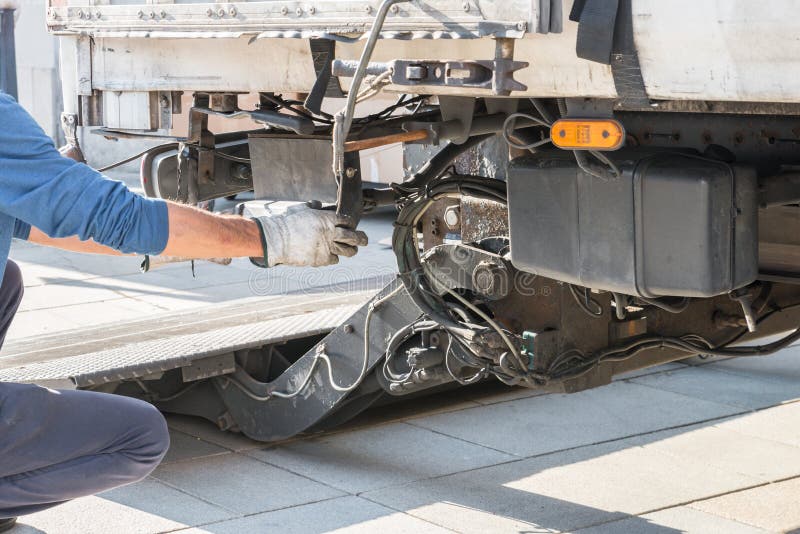 One Mechanic is Operating a Loading Ramp of a Truck Stock Photo - Image ...