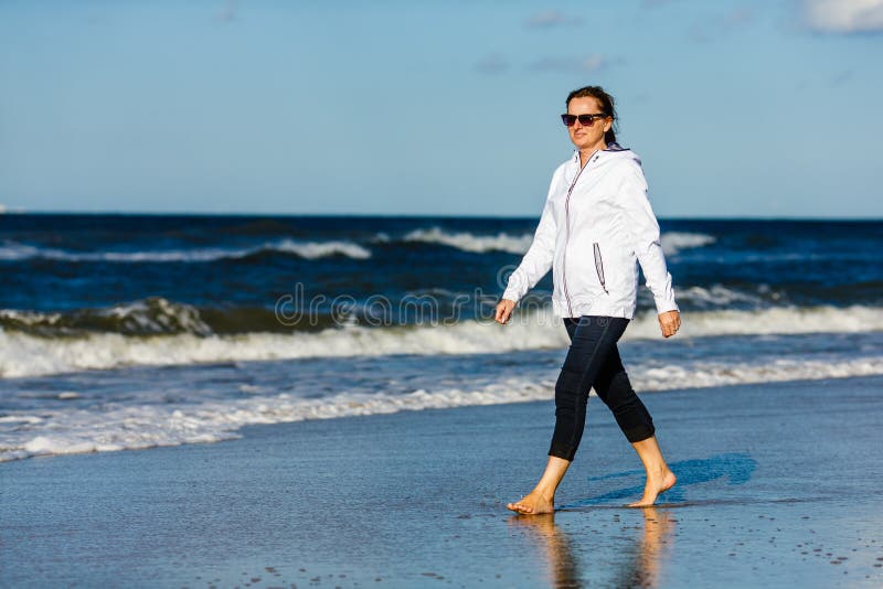 Nordic Walking - Middle-aged Woman Training on Beach Stock Photo ...