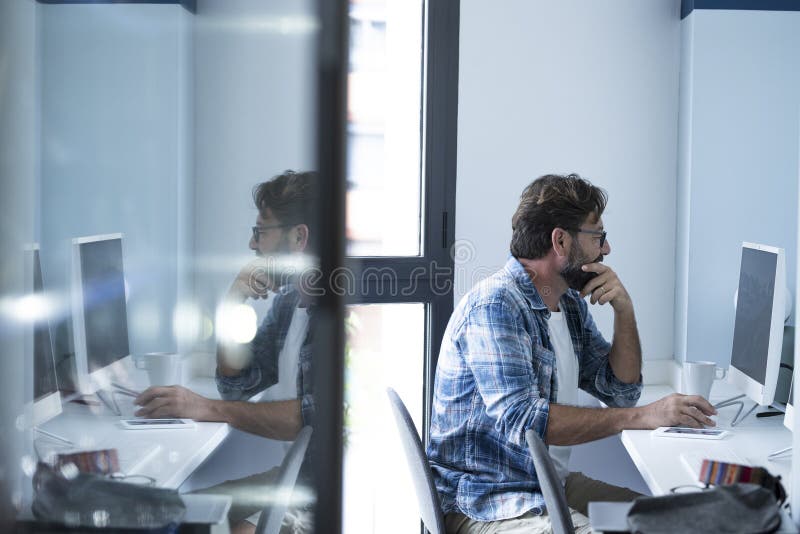 One Modern Worker Using Computer and Looking Screen with Doubts. Office ...