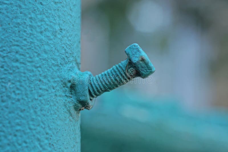 One Old Bent Iron Bolt in a Metallic Blue Wall Stock Photo - Image of ...