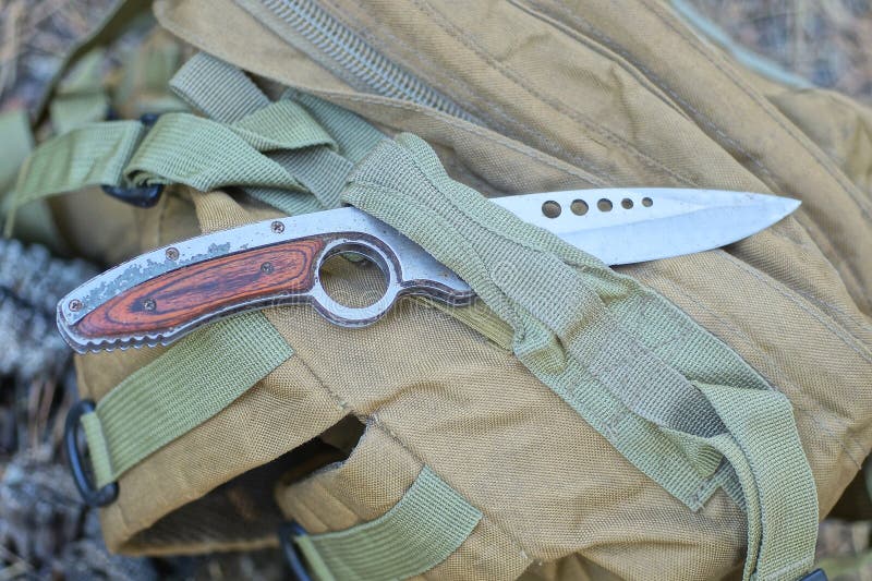 One Old Folding Knife Lies Behind a Brown Strap on a Backpack Stock ...