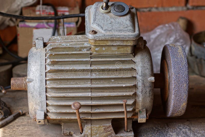 One Old Gray Electric Grinder with a Large Electric Motor and a Round ...