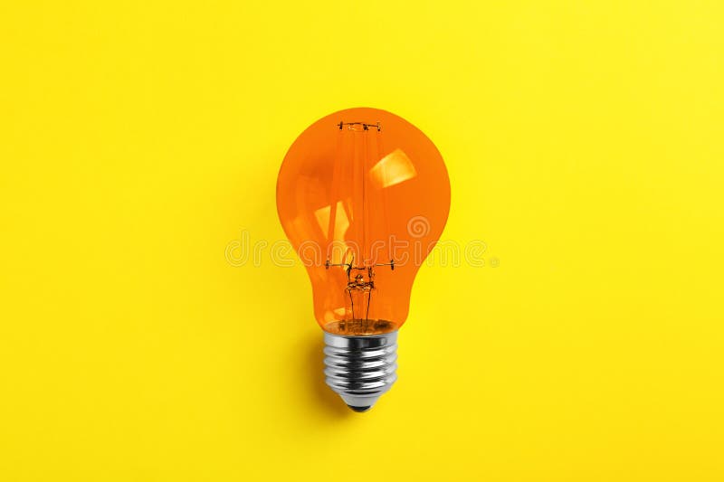 One Orange Light Bulb on Yellow Background Stock Image - Image of lamp ...