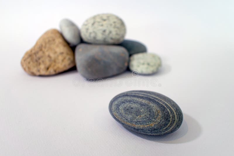 One Oval Shaped Sea Rock in Front of a Pile of Other Sea Rocks. Stock ...