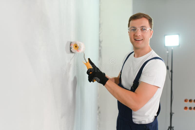 One Painter with Paint Roller Making Wall Prime Coating at Home Repair ...