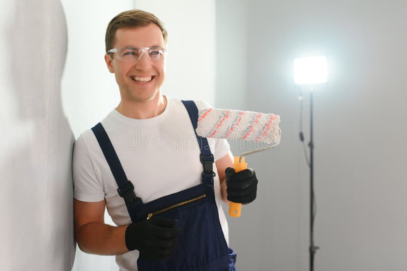 One Painter with Paint Roller Making Wall Prime Coating at Home Repair ...