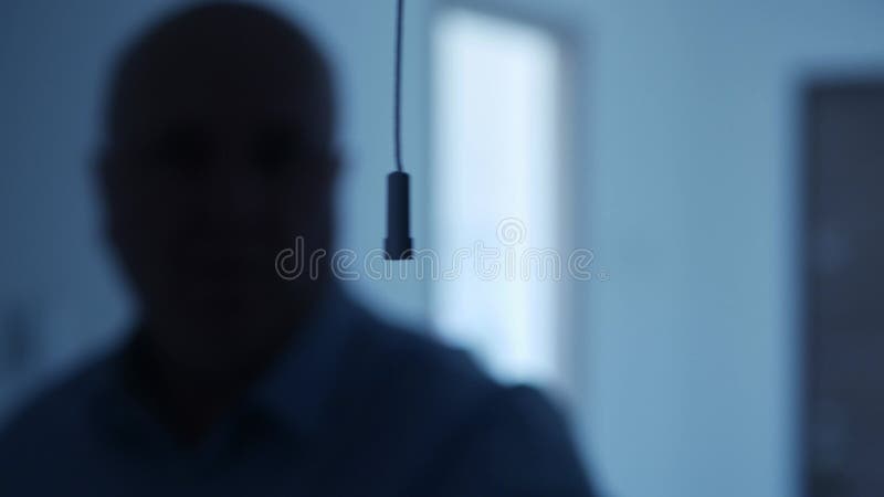 One Person Pull the Switch Cord and Turns on the Light Bulb in a Dark ...