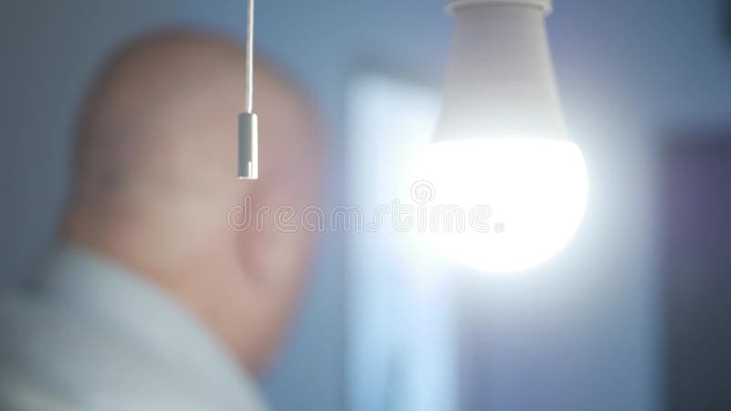 One Person Pull the Switch Cord and Turns Off the Light in a Room ...