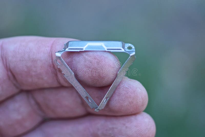 One Piece of Small Grey Metal Triangle on the Fingers Stock Image ...