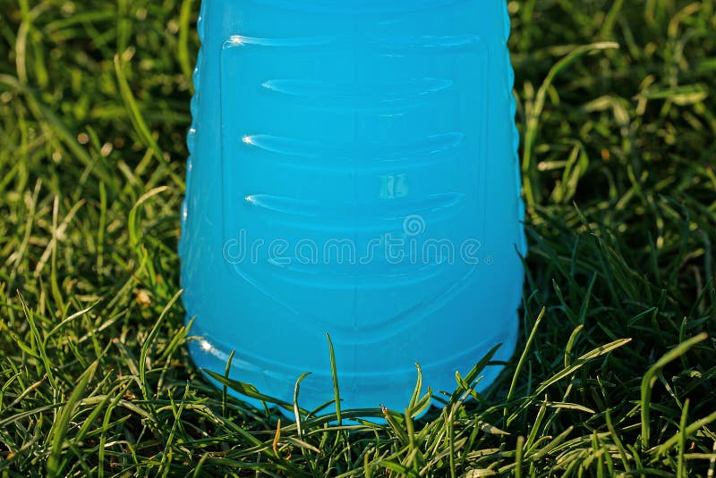 One Plastic Bottle with a Blue Drink Stock Photo - Image of grass ...