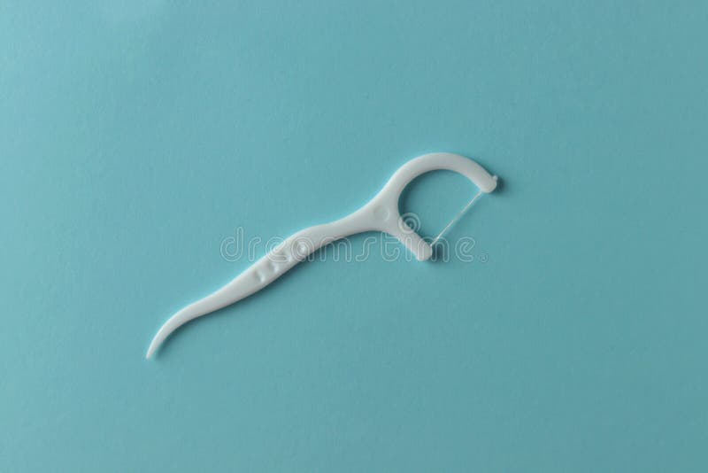Plastic Toothpick with Dental Floss on Blue Background Stock Photo ...